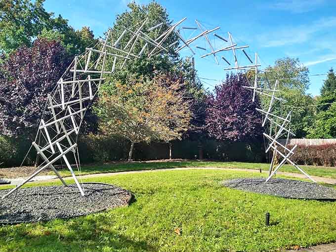The Tensegrity Arch defies gravity with its intricate framework, creating ever-changing patterns as clouds drift overhead.