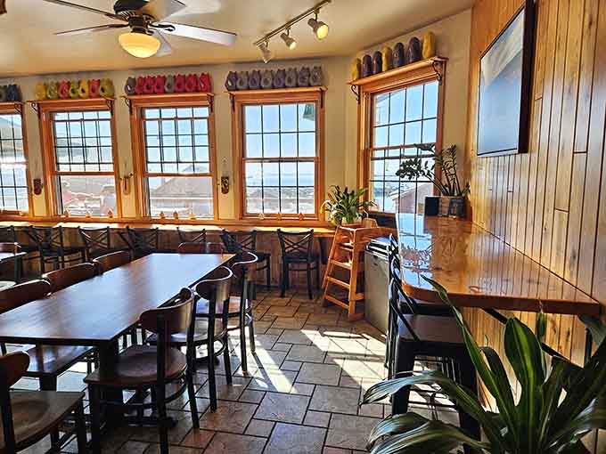 Sunlight streams through generous windows, illuminating a cozy dining space where rustic charm meets lakeside elegance perfectly.