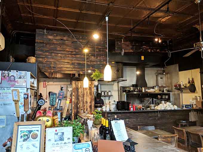 Step inside and discover warm wood tones meet industrial chic, creating the kind of cozy atmosphere where noodle slurping is not just allowed but encouraged.