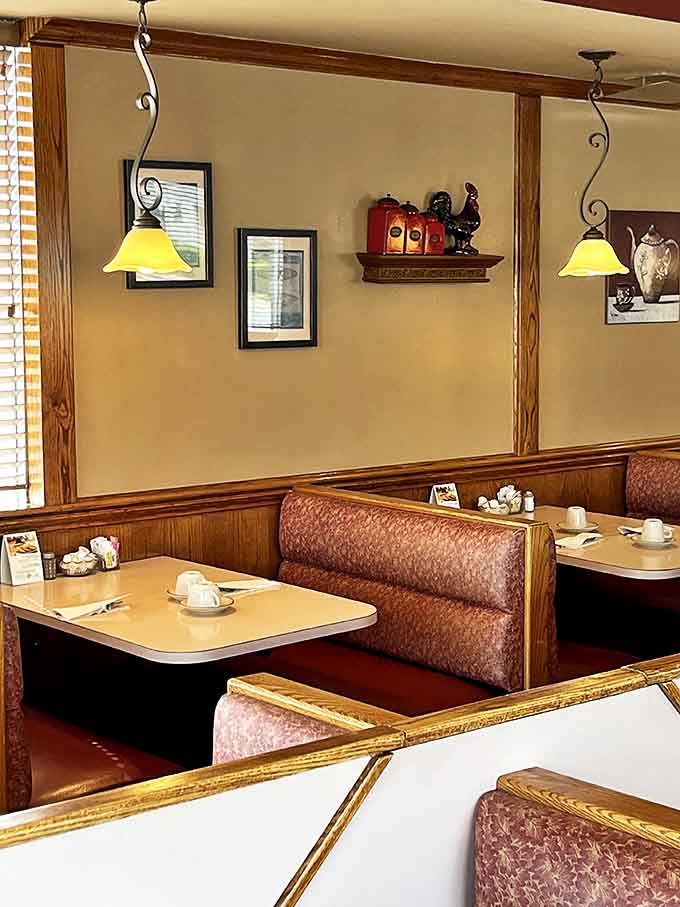 Interior: Cozy booths, warm wood tones, and yellow pendant lights create that perfect "breakfast at home" feeling, minus the dishes.