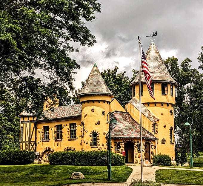 The vibrant yellow facade pops against the landscape, making this whimsical writer's studio look like it was plucked straight from a storybook illustration.