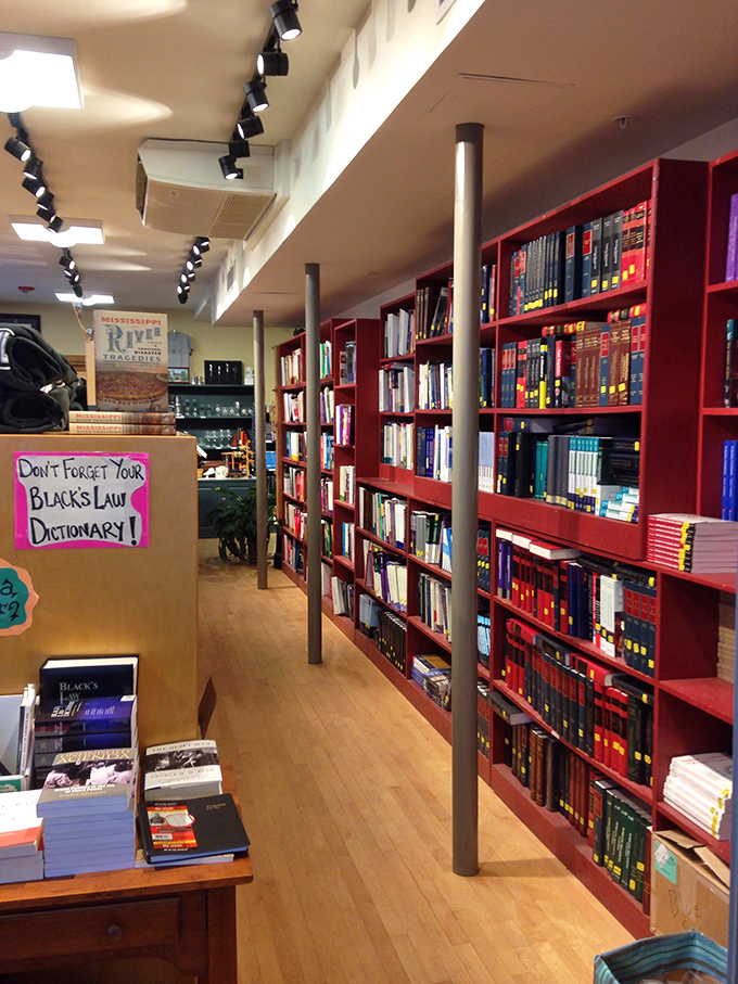 Red bookshelves create a vibrant backdrop for literary treasures, while the warm wooden floors tell stories of countless book lovers who've wandered these aisles.