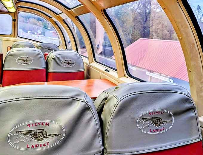 Inside the Silver Lariat dome car, plush seats await passengers beneath panoramic windows that frame nature's ever-changing canvas outside.