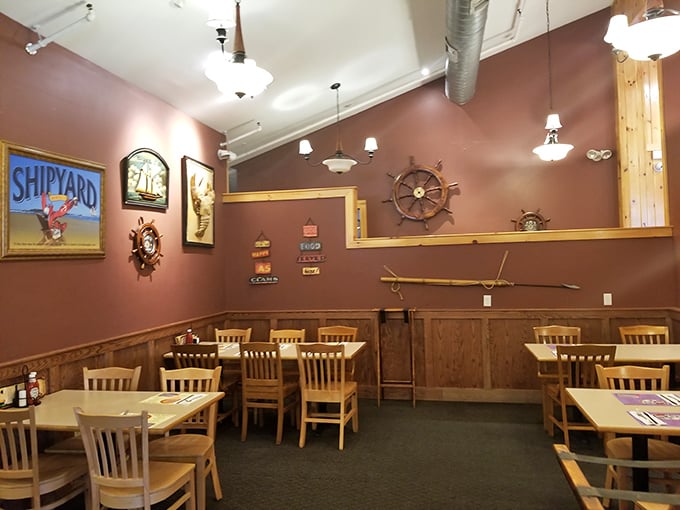 Nautical nostalgia meets dining comfort in this cozy interior where ship wheels and maritime memorabilia create the perfect seafood sanctuary.