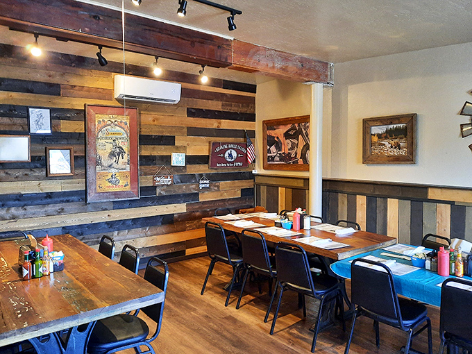 Rustic wood-paneled walls and reclaimed timber create a cozy atmosphere that feels like dining in a mountain cabin.