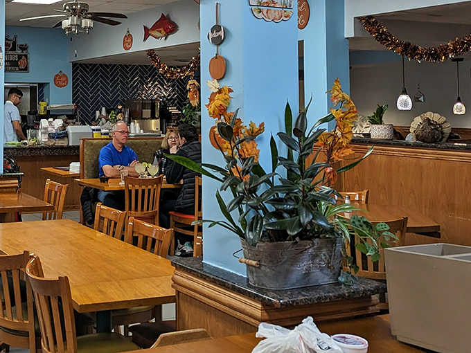 Inside, the warm blue walls and wooden furnishings create an inviting atmosphere where the focus remains squarely on the food.
