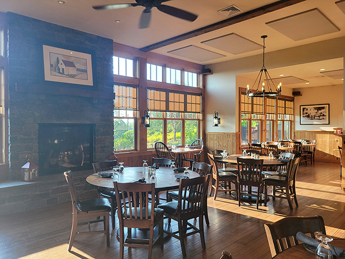 Warm wooden interiors with a stone fireplace create the perfect cozy atmosphere for enjoying a memorable meal.