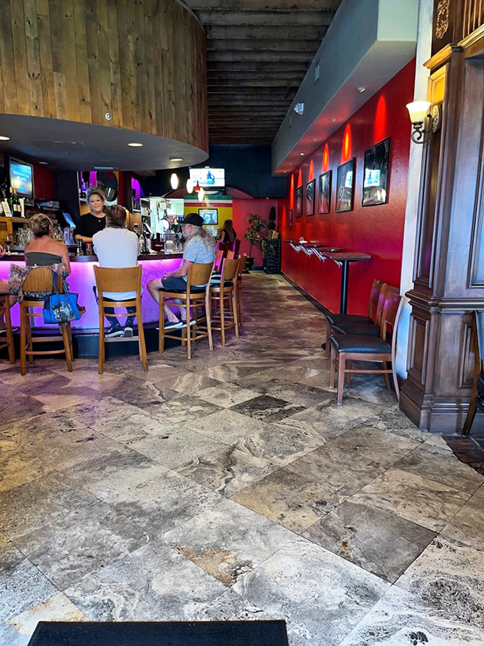 Step inside to find a warm, inviting bar area where vibrant red walls meet rustic stone floors &ndash; the perfect backdrop for Italian culinary magic.