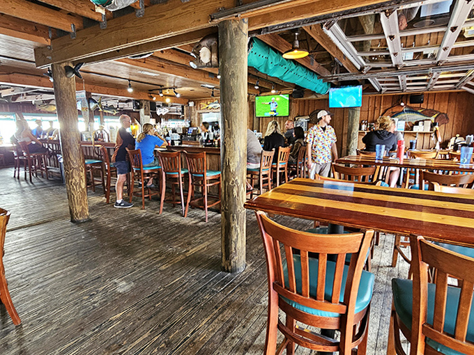 Inside, rustic wooden beams and nautical touches create an atmosphere where time slows down and seafood stories flow as freely as the drinks.