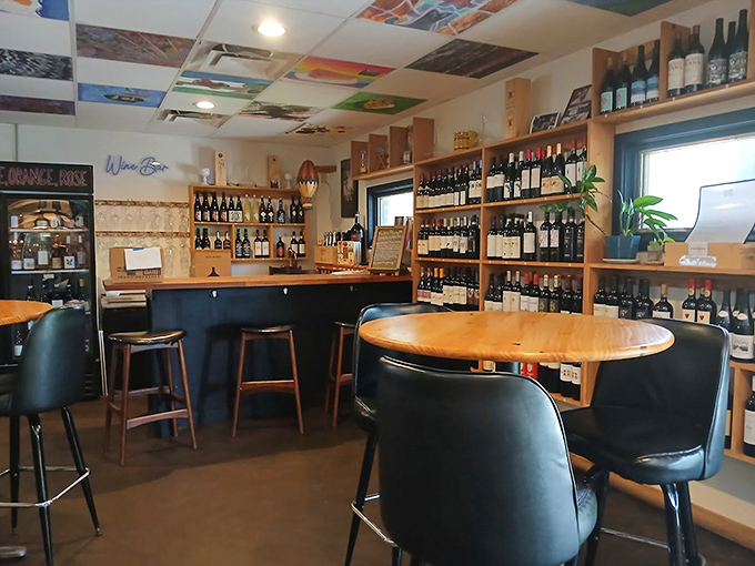 Inside the wine bar, wooden shelves and cozy seating create an intimate atmosphere where conversations flow as freely as the wine.