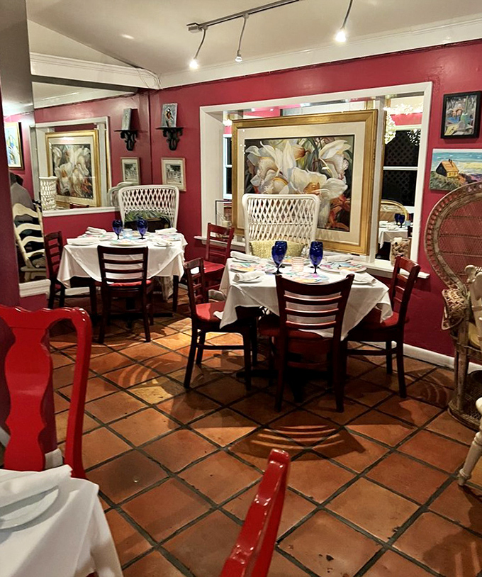 Vibrant crimson walls and elegant place settings create an atmosphere that's both sophisticated and warmly inviting.