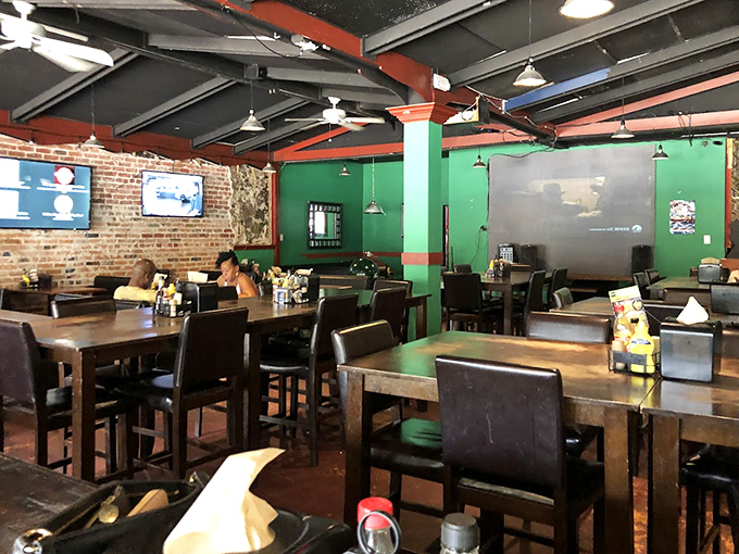 Exposed brick meets comfy wooden tables in this cozy dining space where ceiling fans lazily spin above conversations and laughter.