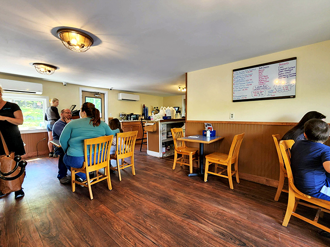 Simple wooden tables and chairs create a homey atmosphere where the food and river views take center stage.