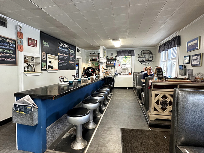 Classic counter seating with chrome stools invites solo diners to perch and chat while watching the breakfast magic unfold.
