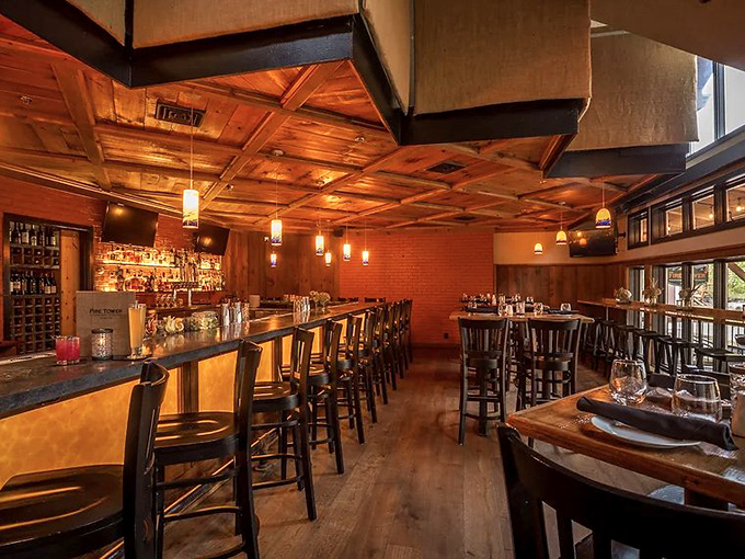 Warm wooden coffered ceilings and ambient lighting create the perfect mountain tavern atmosphere – cozy enough for winter, inviting year-round.