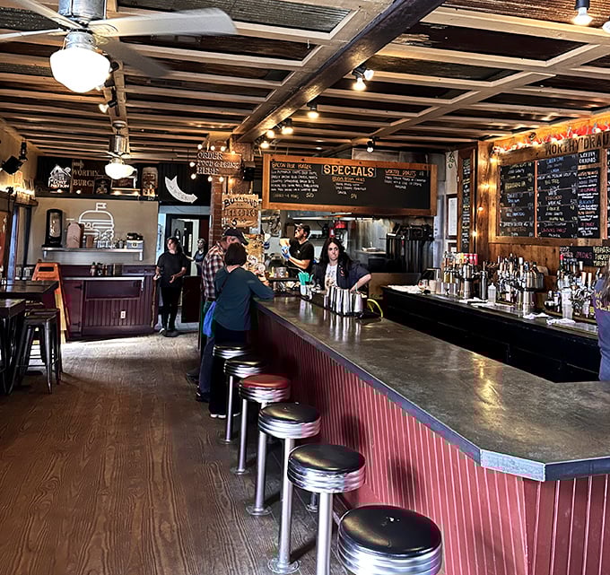 Exposed beams, classic bar seating, and warm lighting create that magical space between rustic charm and genuine comfort.