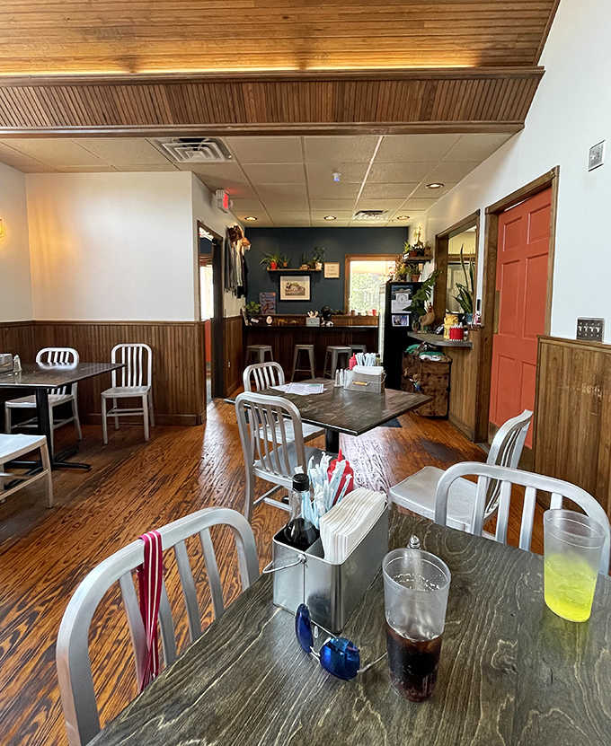 Warm wooden wainscoting and simple metal chairs create an unpretentious atmosphere where the food becomes the undisputed star.