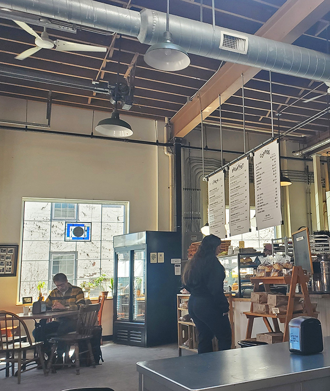 Industrial chic meets cozy comfort inside August First, where exposed ductwork and pendant lighting create the perfect backdrop for morning indulgence.