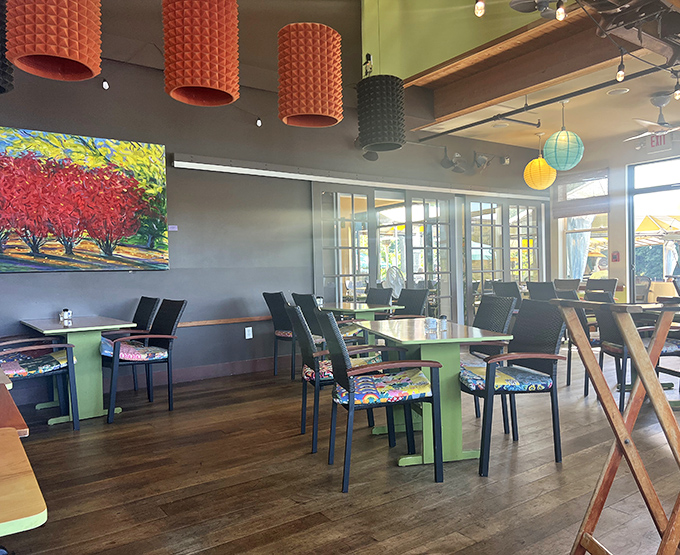 Modern meets cozy in The Marina's thoughtfully designed interior, where colorful pendant lights and vibrant artwork create a warm, inviting atmosphere for hungry travelers.