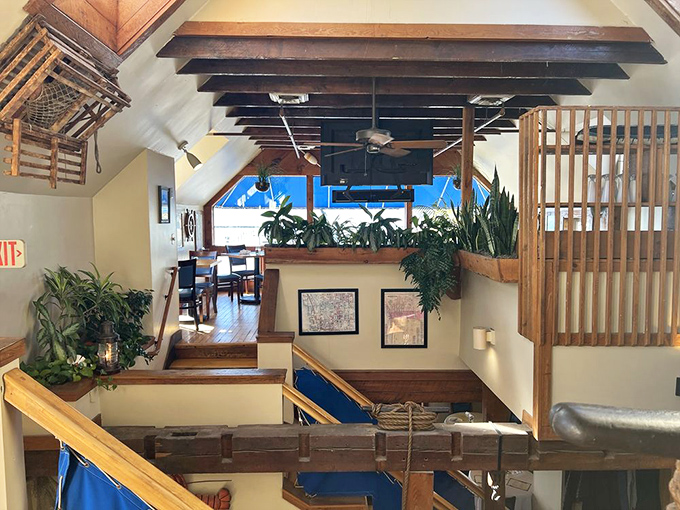 Multi-level dining spaces create intimate nooks throughout the restaurant, where wooden beams and nautical touches transport diners to a sophisticated ship's galley.