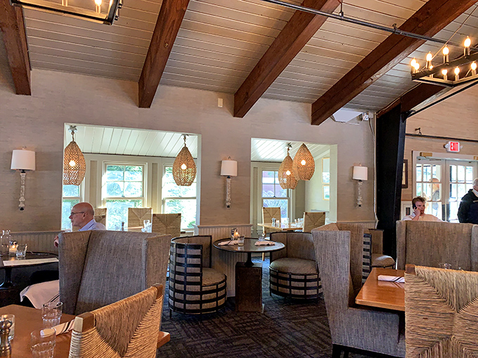 Exposed beams meet woven pendant lights in a dining room that whispers "coastal elegance" without shouting it through a foghorn.