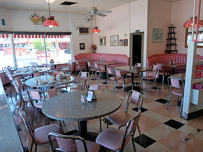 Step inside and time-travel to the 1950s with pink vinyl booths, chrome accents, and a checkerboard floor that screams "American classic."