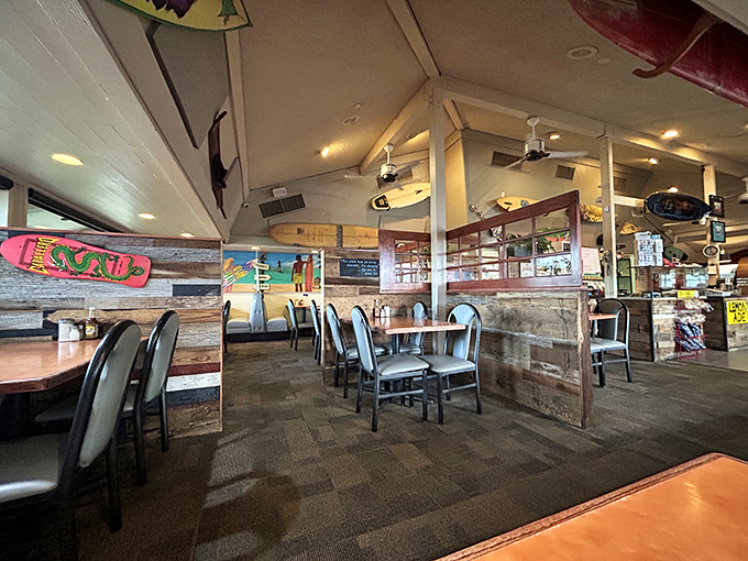 Rustic wooden dividers create cozy dining nooks while surfboards overhead bring unexpected beach vibes to this Phoenix breakfast haven.