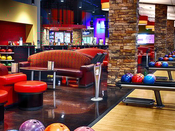 Plush red seating areas surround the bowling lanes, offering comfort that's leagues beyond the plastic chairs of yesteryear's alleys. Bowling in style!