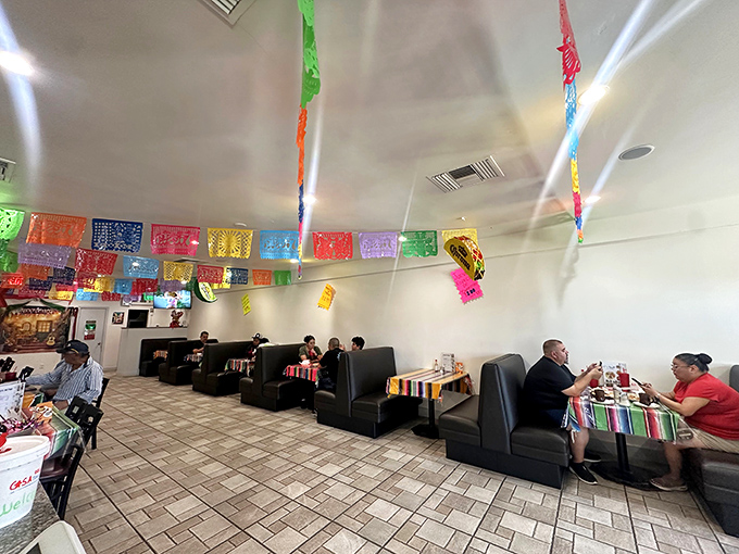 Inside, colorful papel picado flags dance overhead while comfortable booths invite diners to settle in for a proper Mexican feast.