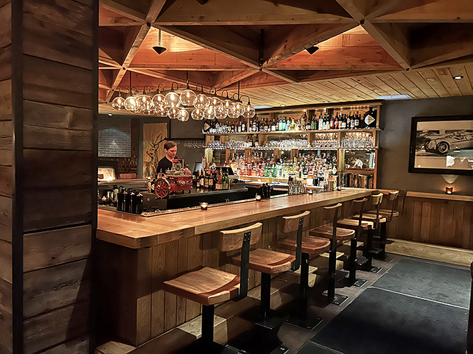 The bar at Hen of the Wood combines rustic charm with sophisticated craftsmanship &ndash; wooden beams overhead, expertly stocked shelves, and the promise of exceptional drinks.