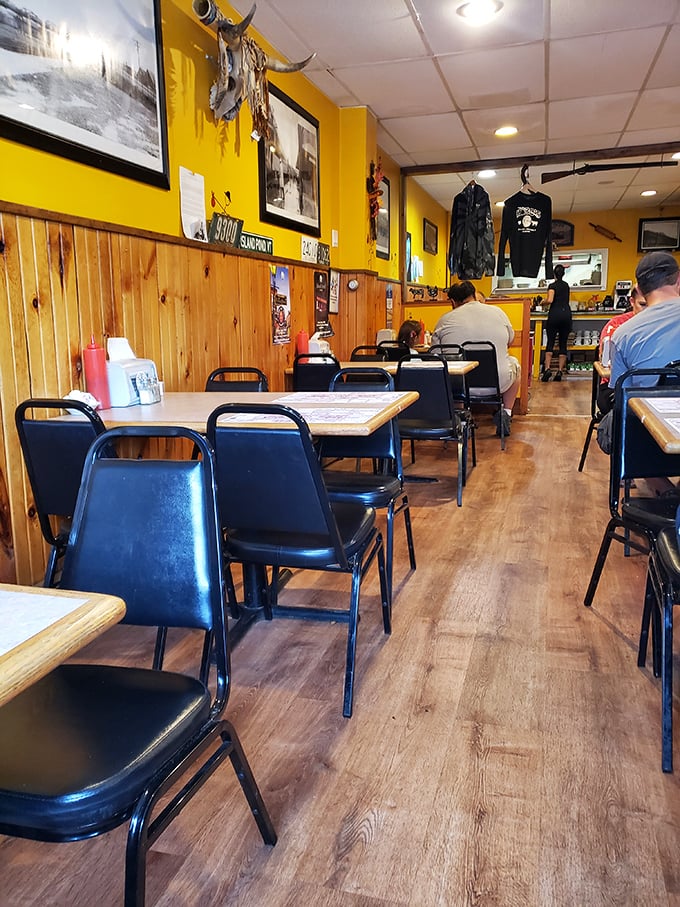 Yellow walls and pine wainscoting create the perfect backdrop for serious eating &ndash; no-nonsense chairs await hungry diners.
