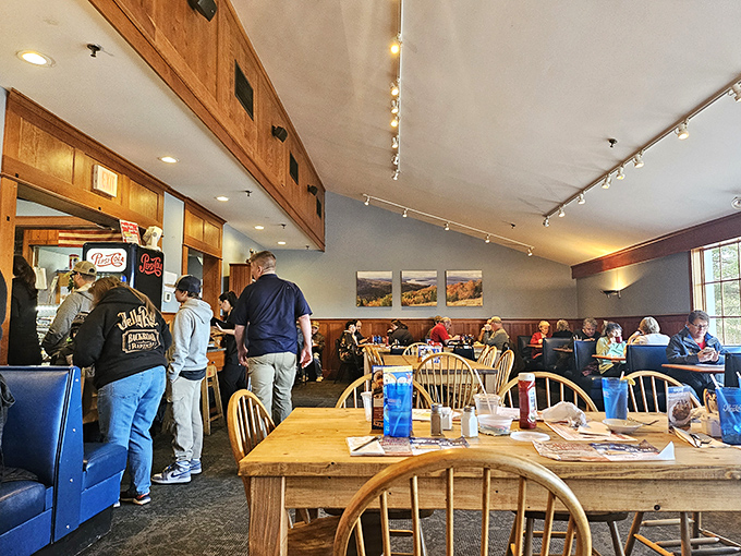 Inside, wooden chairs and blue booths create that perfect "been here forever" vibe where conversations flow as freely as the coffee.