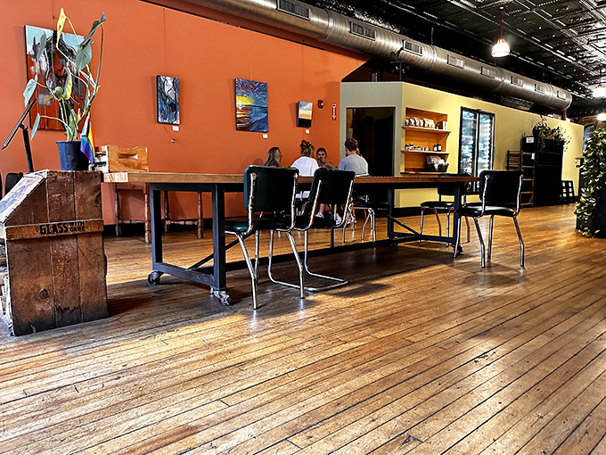 Inside, warm terracotta walls and polished wooden floors create a cozy atmosphere where locals gather around industrial-style communal tables.