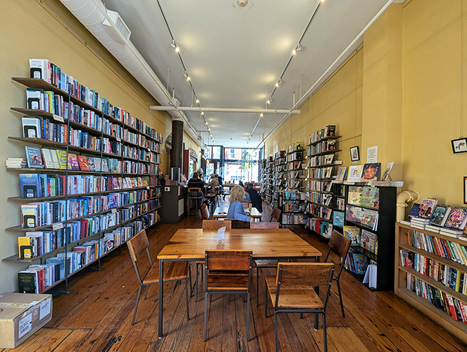 Warm yellow walls and wooden shelves create the perfect backdrop for literary exploration between delicious bites.
