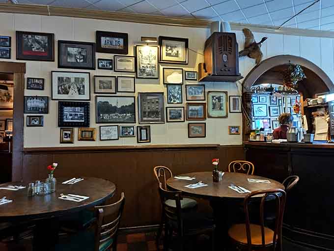 Vintage photographs blanket the walls like a family album, while bentwood chairs and warm lighting create the perfect "stay awhile" vibe.