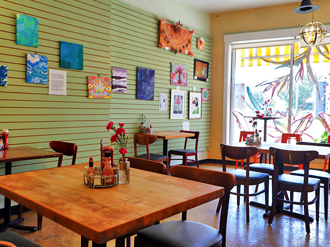 Interior: Mint green walls adorned with local artwork create the perfect backdrop for morning conversations and coffee contemplation.