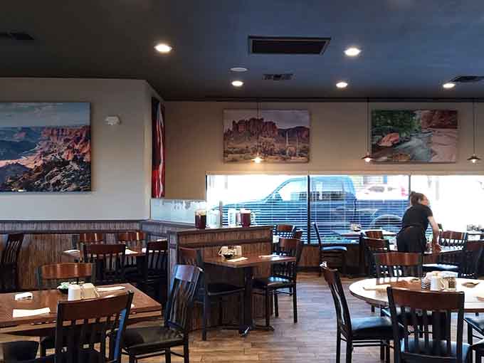 The warm, inviting dining room features comfortable seating and Arizona landscape photography that sets a relaxed tone for your meal.