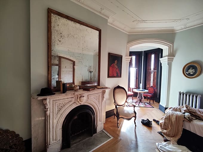 Time-worn elegance greets visitors in this parlor, where the aged mirror has witnessed more than a century of reflections.