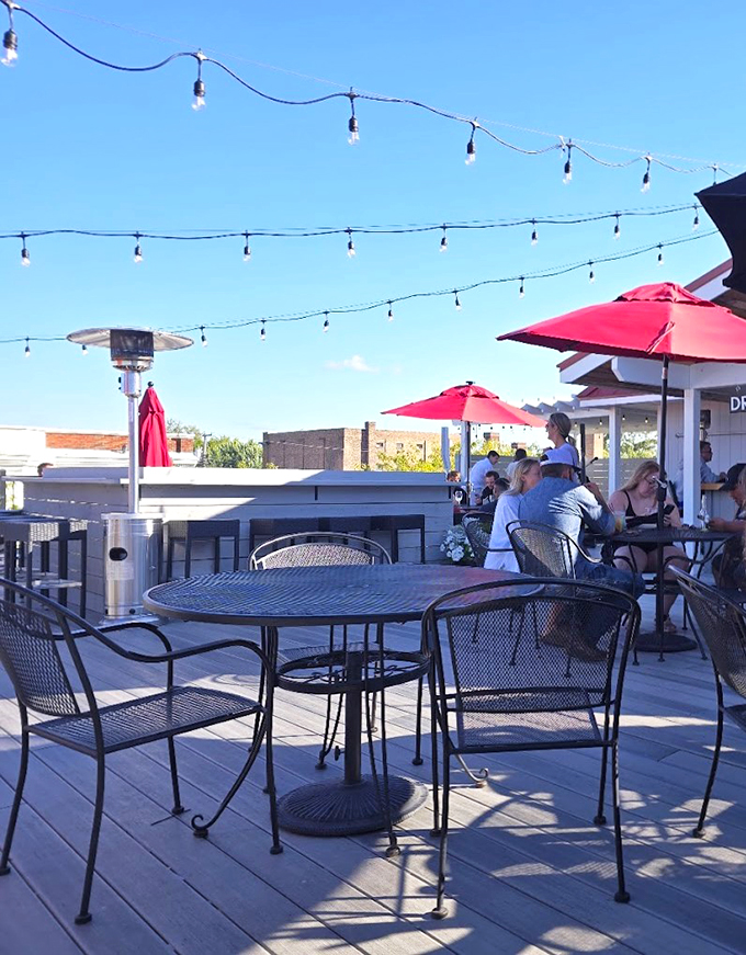 Strings of lights, red umbrellas, and the buzz of happy diners—this rooftop oasis is where food meets fun, and memories are made al fresco.