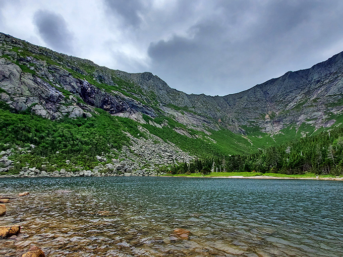 Reflections dance across this alpine pond's crystal surface, creating nature's perfect mirror image of the surrounding granite walls.