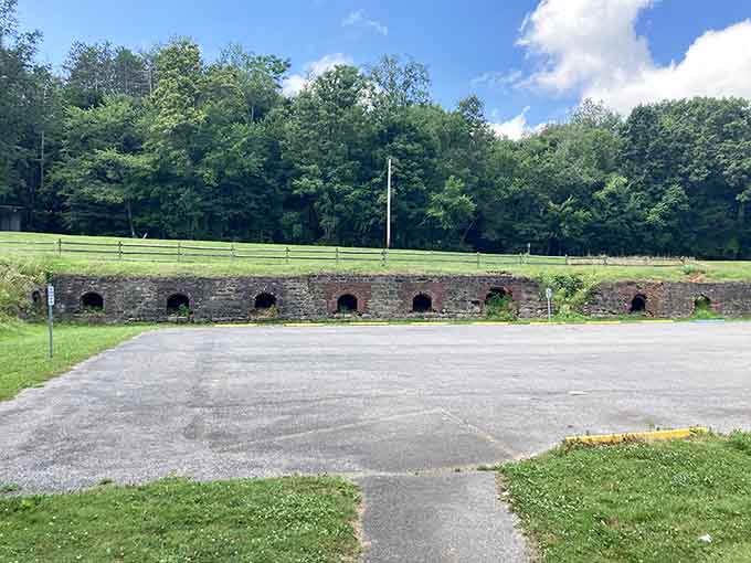 Row after row of beehive ovens stretch across the landscape, their weathered surfaces telling stories of fires that burned over a century ago.
