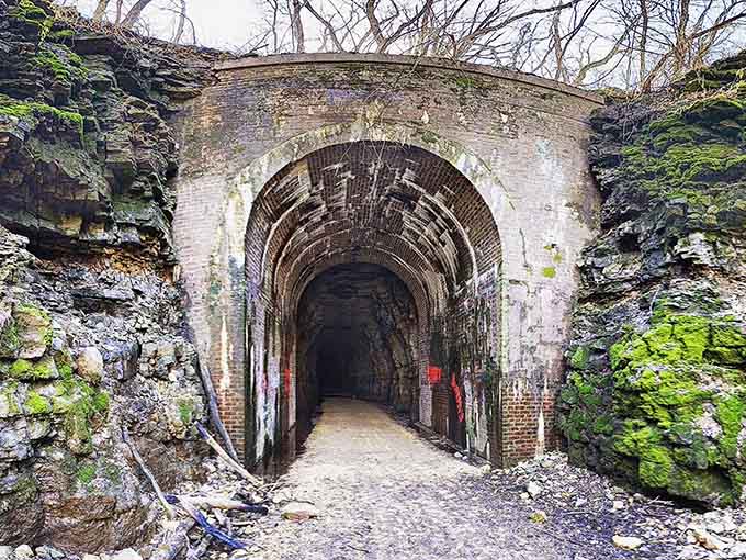 Little Sand Cave sign stands sentinel at the trail junction, promising geological wonders just around the bend.