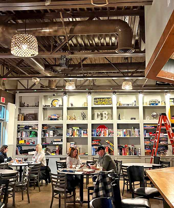 Industrial-chic meets cozy comfort in this interior where exposed ductwork and pendant lighting create the perfect backdrop for food and fun.