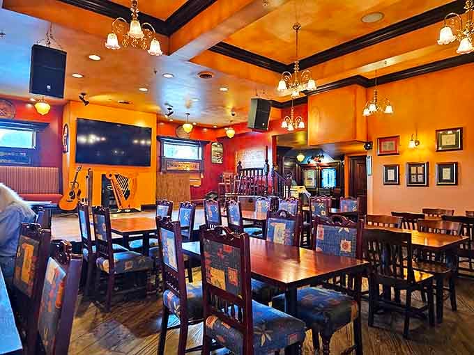 Warm amber lighting bathes rich wood interiors, creating that perfect pub atmosphere where conversations flow as easily as the drinks.