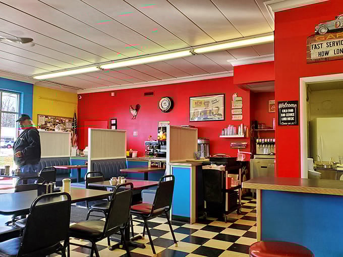 Classic diner vibes with vibrant red walls and checkered floors - where every seat feels like you've stepped into a time capsule of American comfort.