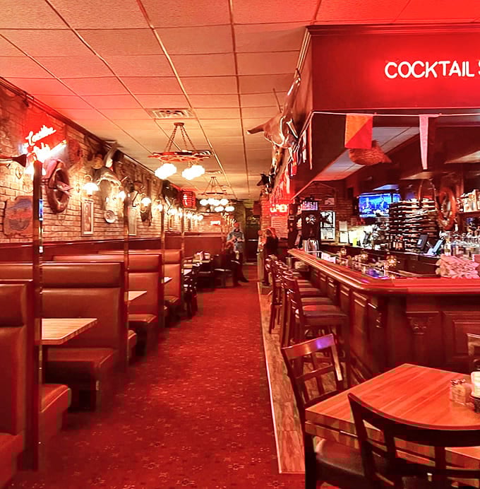 Inside: Warm red lighting bathes the dining room in a cozy glow, while nautical touches transport diners to a seaside haven.