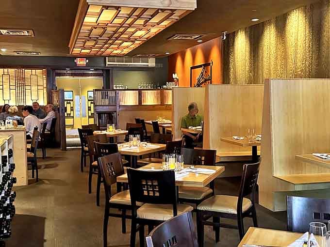 Warm wood tones and elegant lighting create an atmosphere that's both sophisticated and welcoming &ndash; like dining in a friend's stylish home.