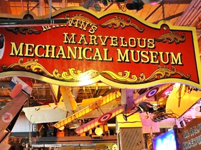 Inside Marvin's Marvelous Mechanical Museum, vintage planes hang from the ceiling while colorful arcade machines create a wonderland of mechanical delights.