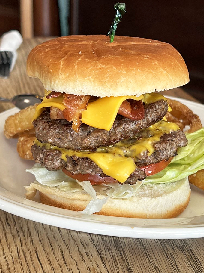 Holy cow! This towering masterpiece is the stuff of burger dreams. Juicy patties, melty cheese, and crispy bacon &ndash; it's a flavor explosion waiting to happen.