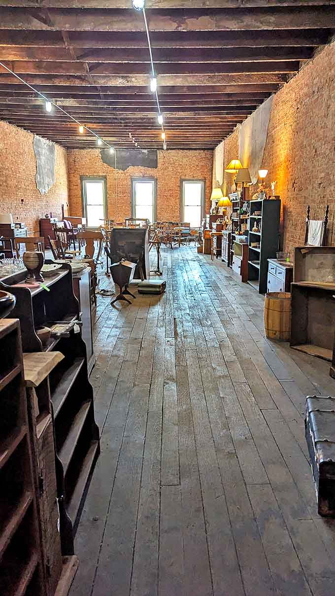 Exposed beams and string lights illuminate collections where every chair, lamp, and shelf has a story waiting to be discovered.